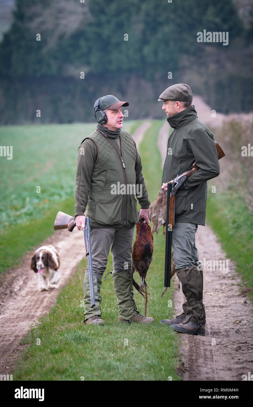 Traditional English game shooting in the autumn countryside with gun ...