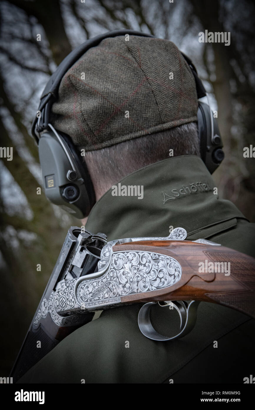 Traditional English game shooting in the autumn countryside with gun ...