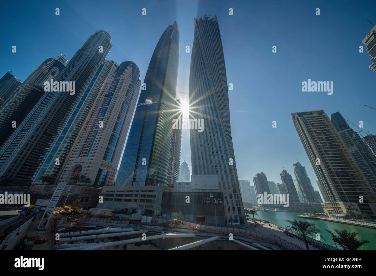Residential towers of the Dubai Marina split the sun into a crown of ...