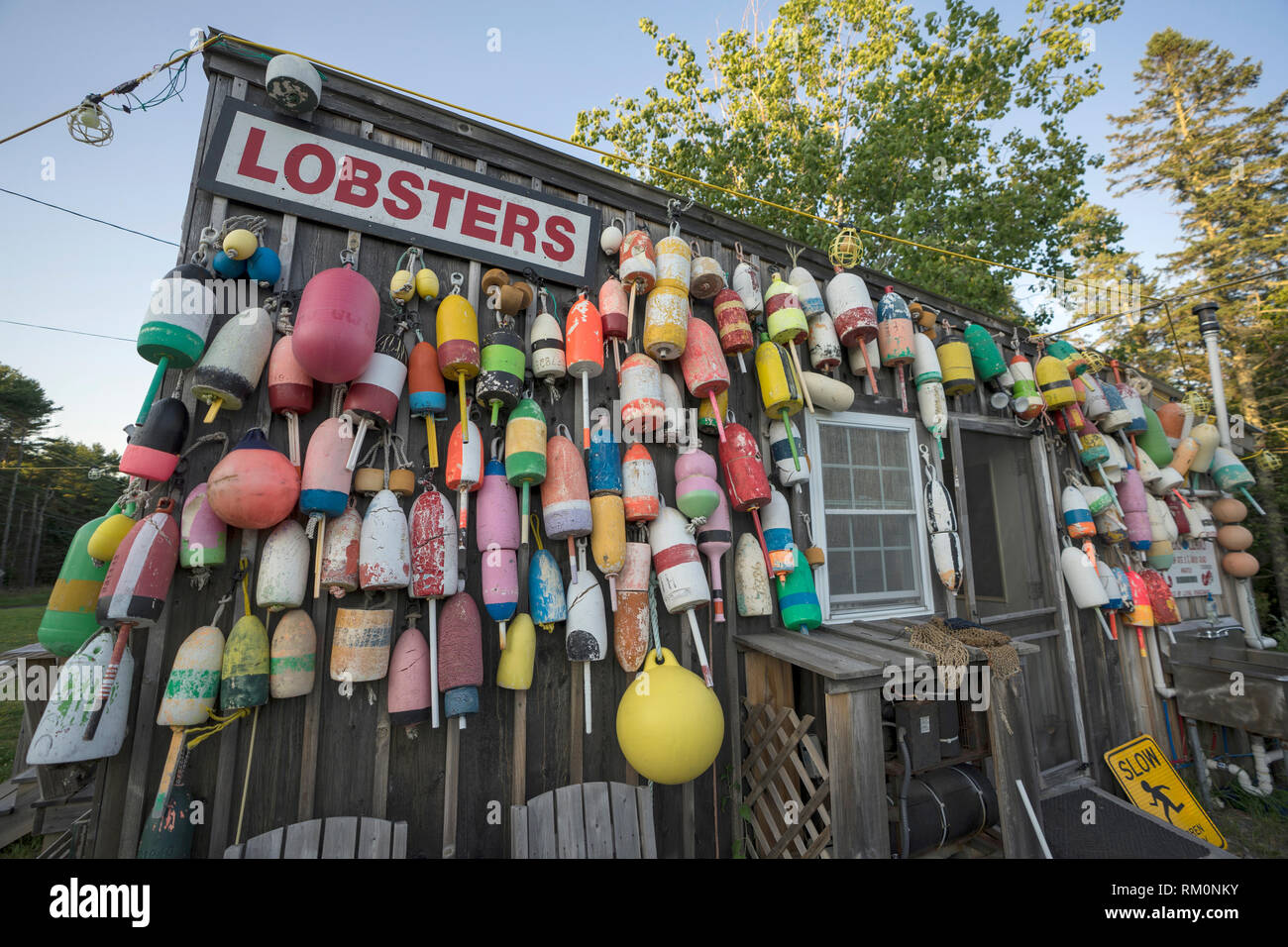 A lobster shack is covered with colourful buoys in Maine in USA Stock ...
