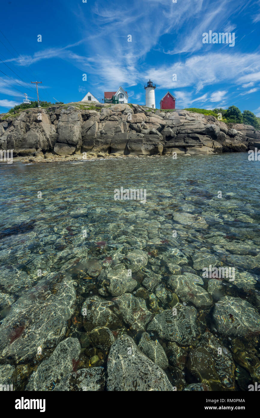 The Nubble Point Lighthouse crowns an island across a narrow channel in ...