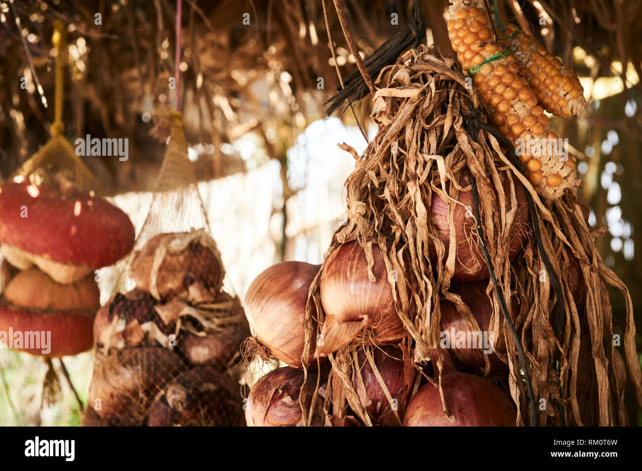 Vegetables hanging from a market stall on the side of the road just ...