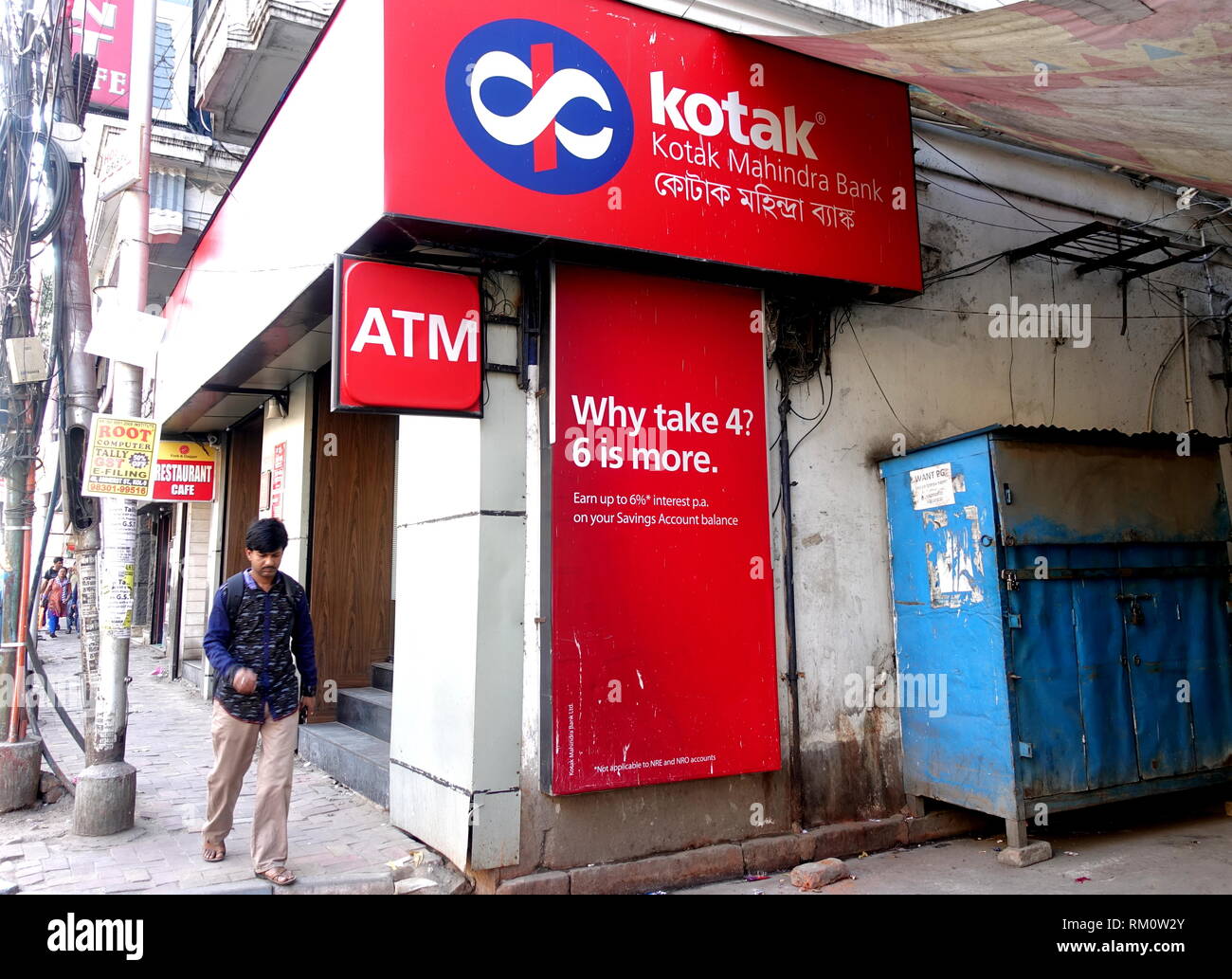 A Man Seen Walking In Front Of The Kotak Mahindra Bank ATM Operation