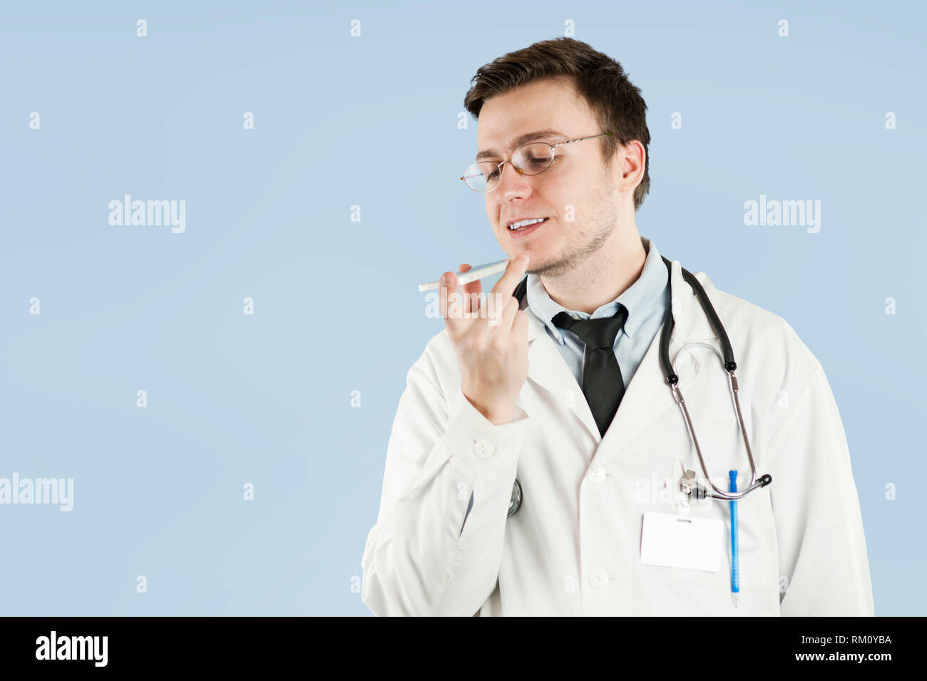 Young cute doctor student with a smartphone in his hands talking to ...