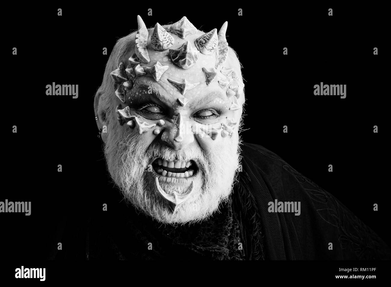 Evil face with dragon skin and grey beard Stock Photo - Alamy
