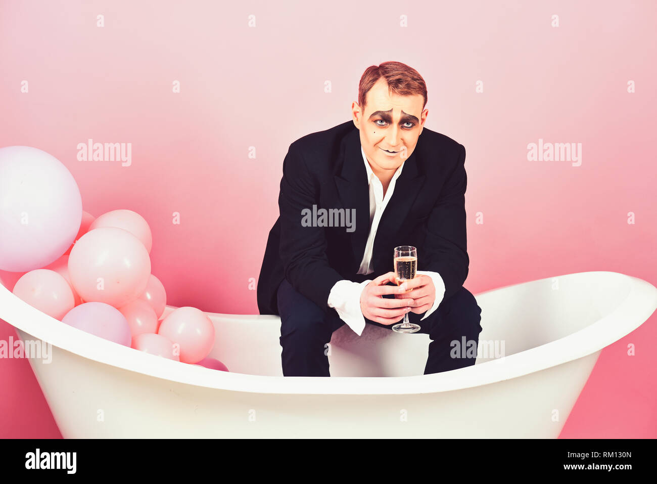 Drinking sparkling wine for festive occasions. Mime actor has ...