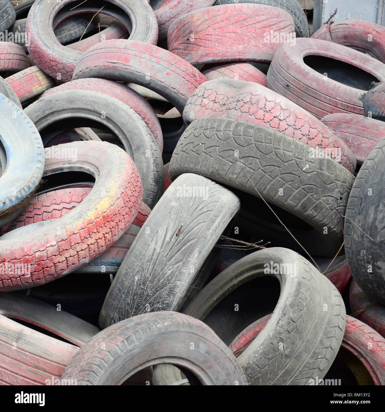 A picture of many old used tires left on a waste dump. The picture of an ecological problem and ...