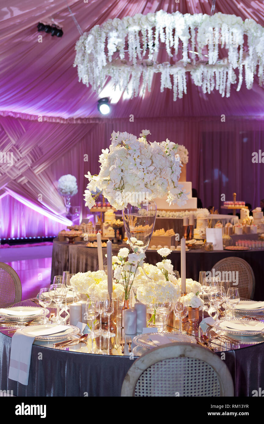 Moody backlit ambience of a wedding reception, luxury elegant table ...