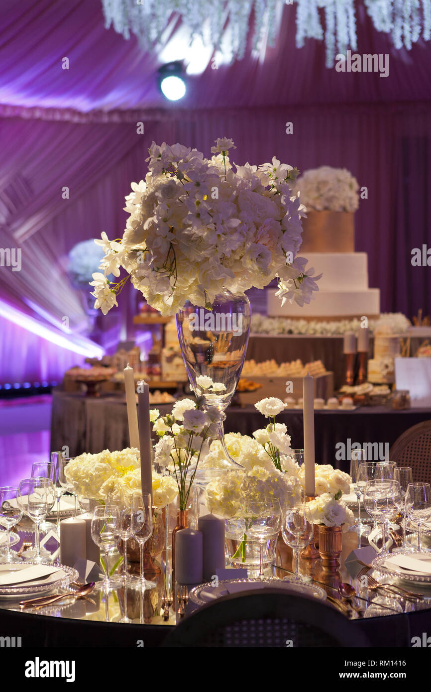 Moody backlit ambience of a wedding reception, luxury elegant table ...