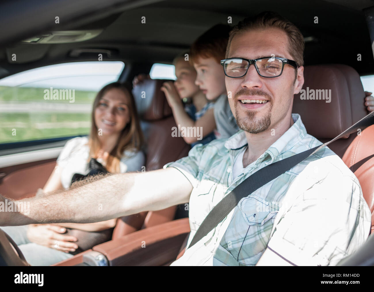side view.happy father driving a car Stock Photo - Alamy