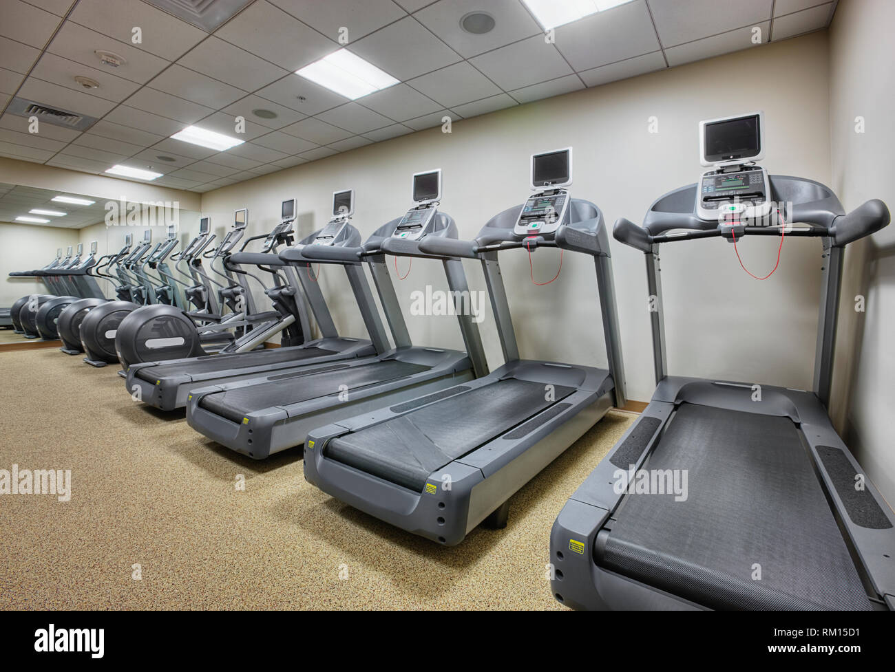 Treadmills in a row at gym Stock Photo - Alamy
