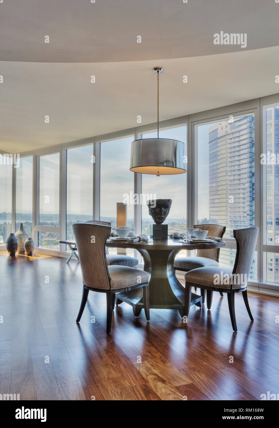 Dining room in luxury highrise apartment Stock Photo - Alamy
