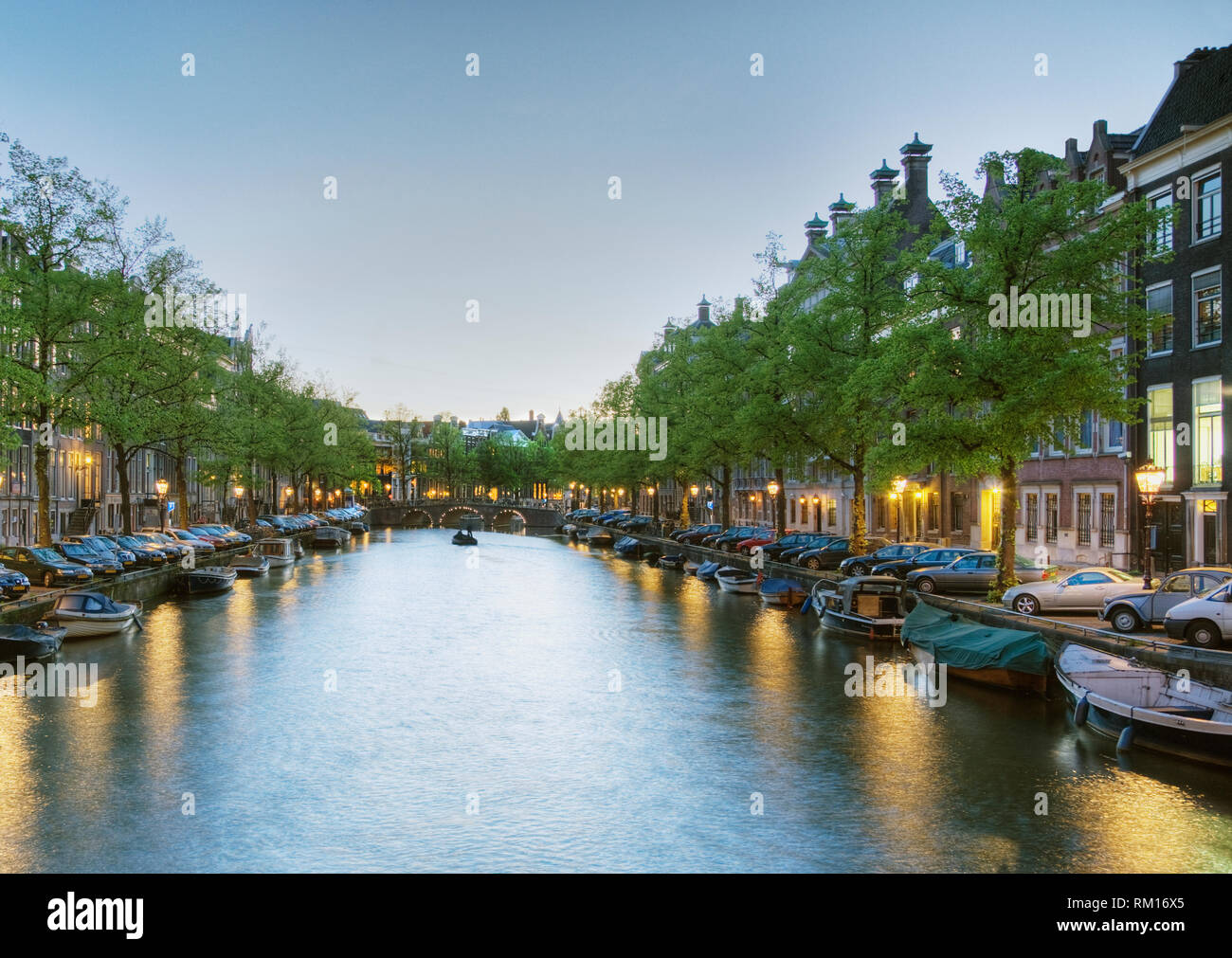 Boats in a Tree Lined Canal at Dusk Stock Photo - Alamy