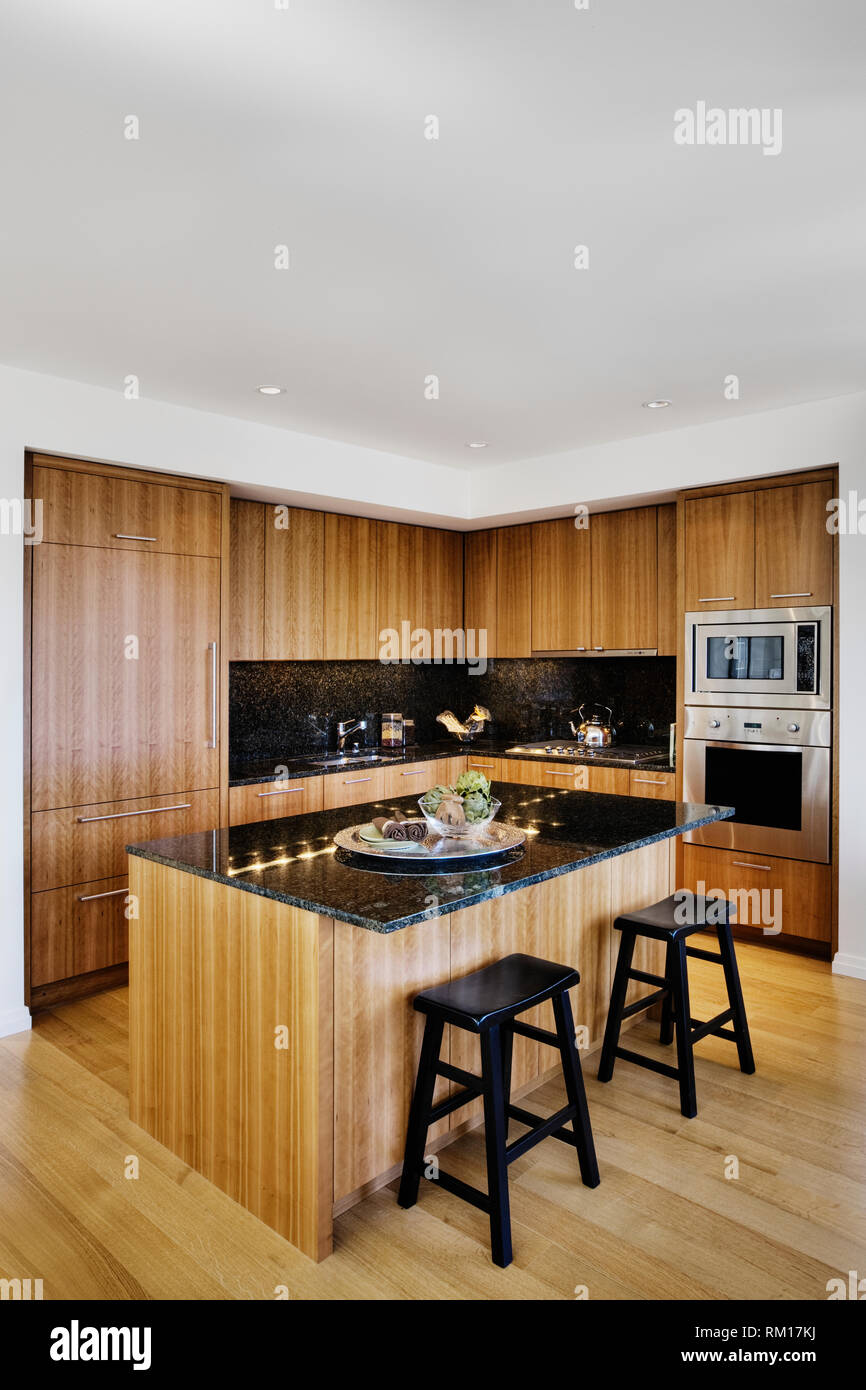 Wood cupboards in modern kitchen Stock Photo - Alamy