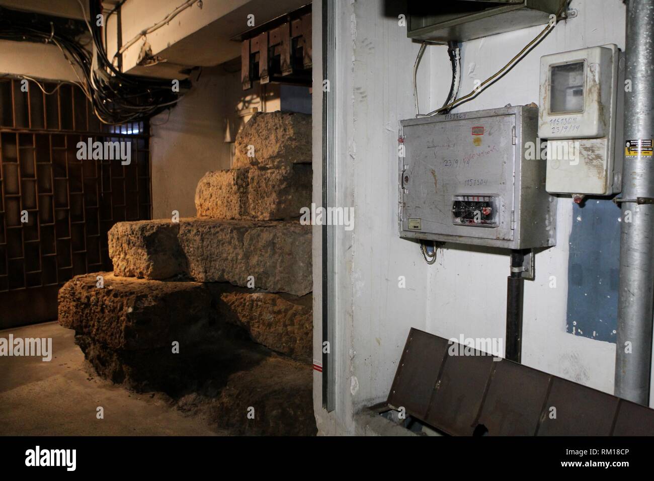 A part of ancient wall at the basement of modern building in central ...