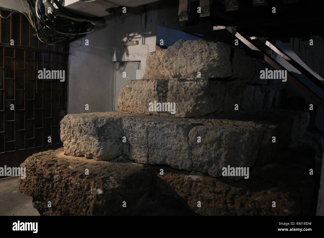 A part of ancient wall at the basement of modern building in central ...