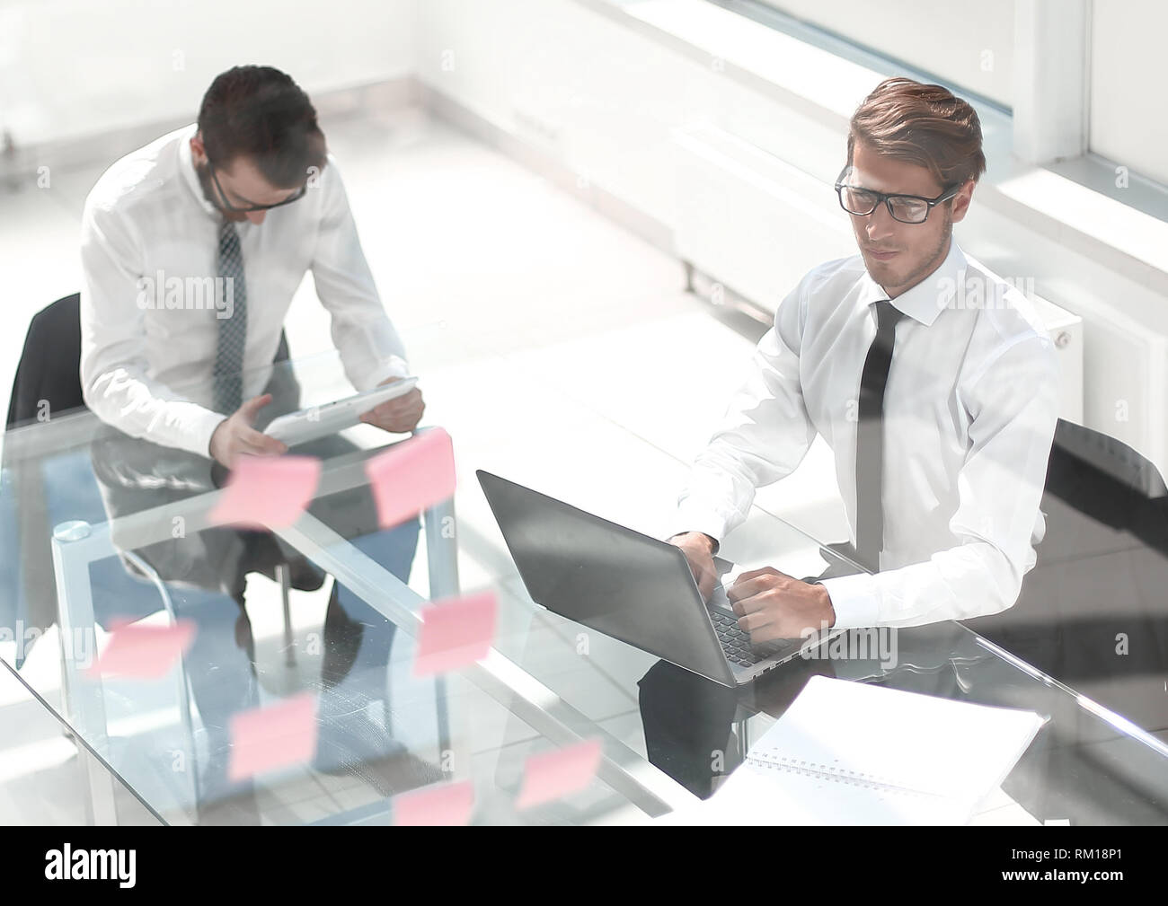 two employees sitting at the Desk Stock Photo - Alamy