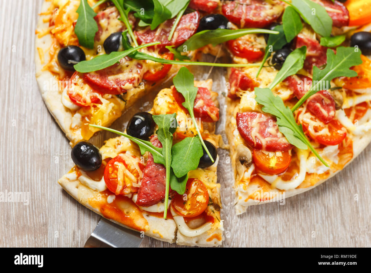 Taking slice of pizza,melted cheese is dripping Stock Photo - Alamy