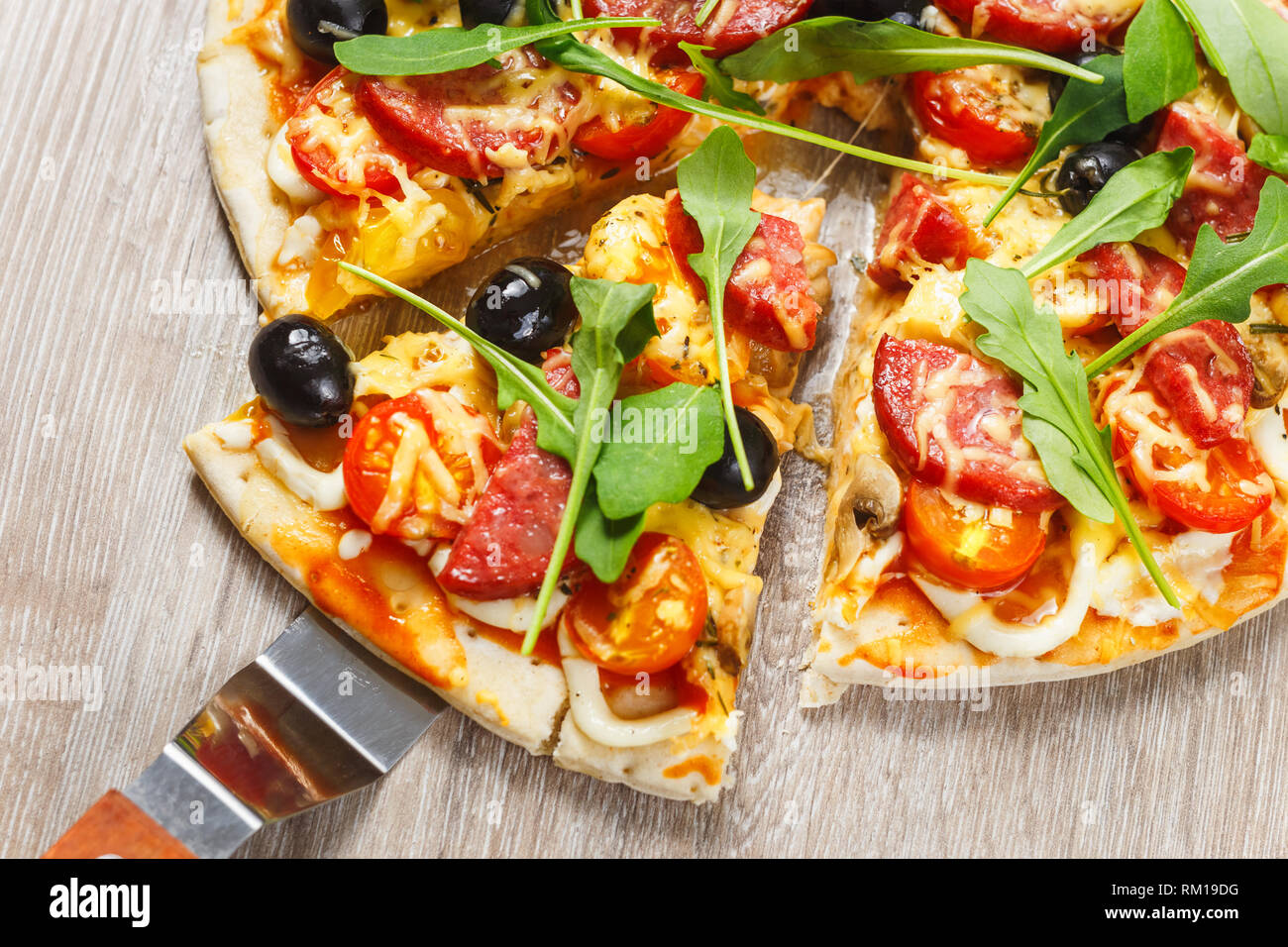 Taking slice of pizza,melted cheese is dripping Stock Photo - Alamy