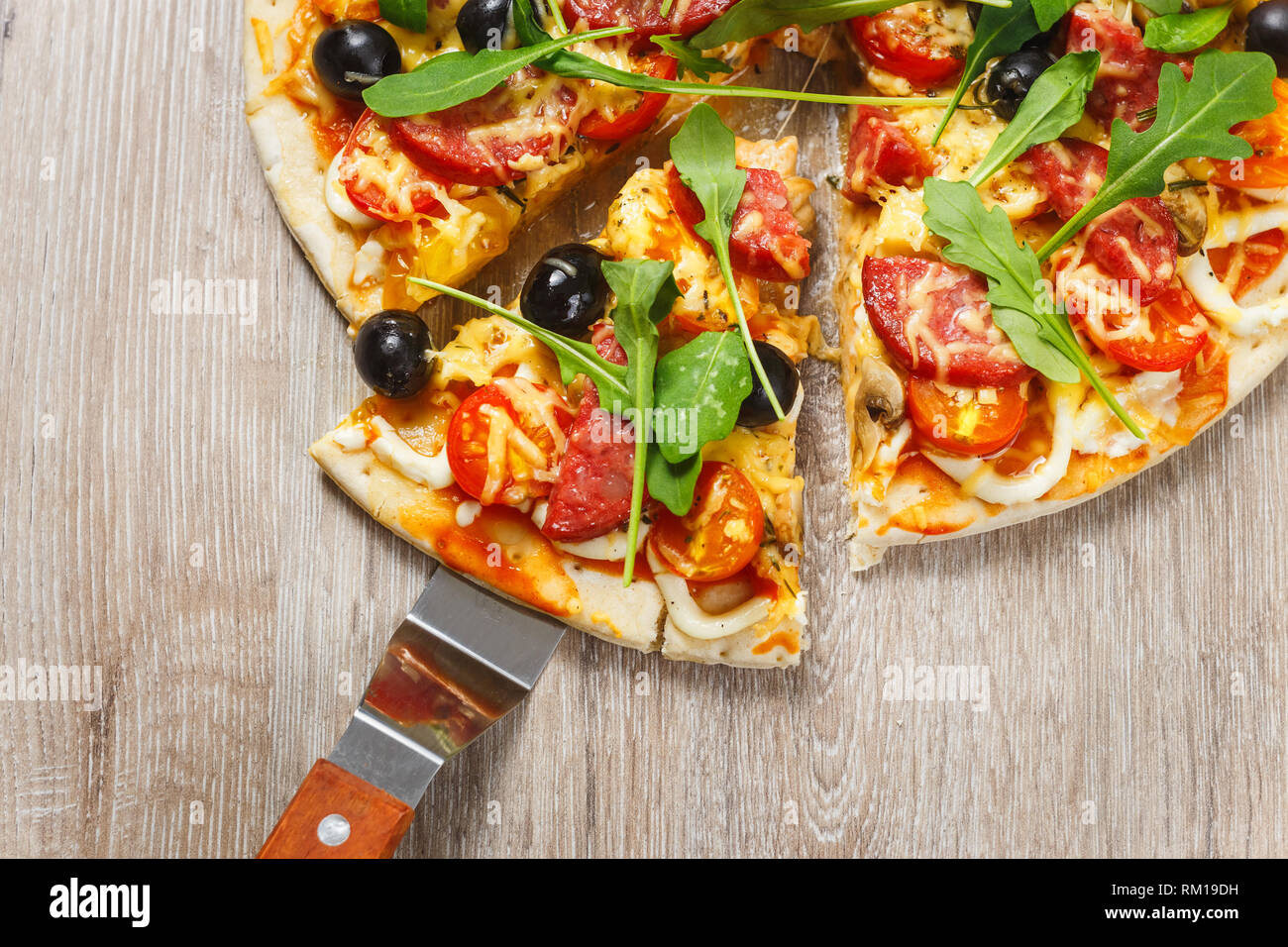 Taking slice of pizza,melted cheese is dripping Stock Photo - Alamy