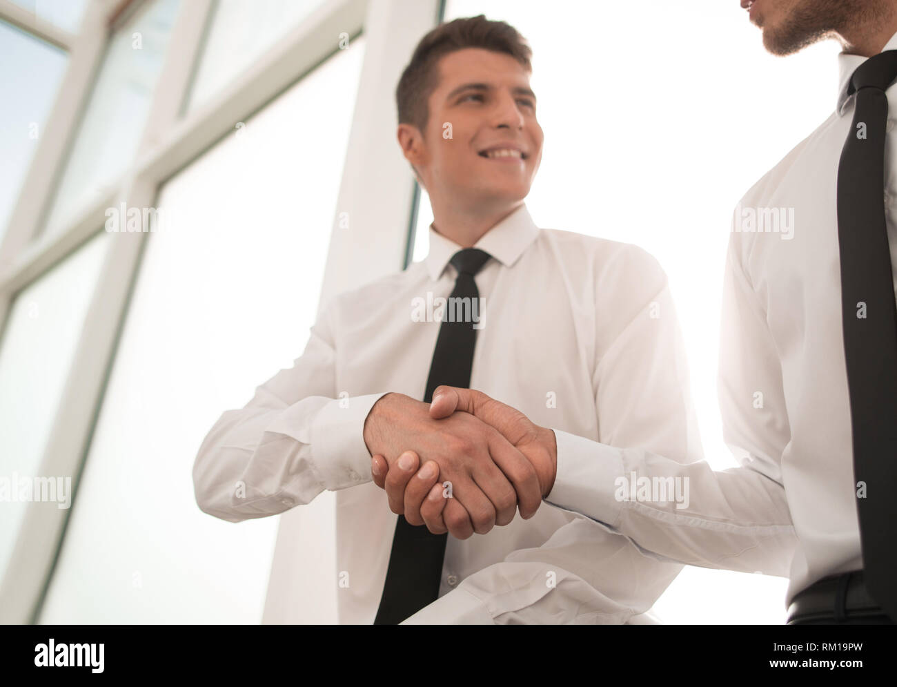 handshake of employees in the office Stock Photo - Alamy