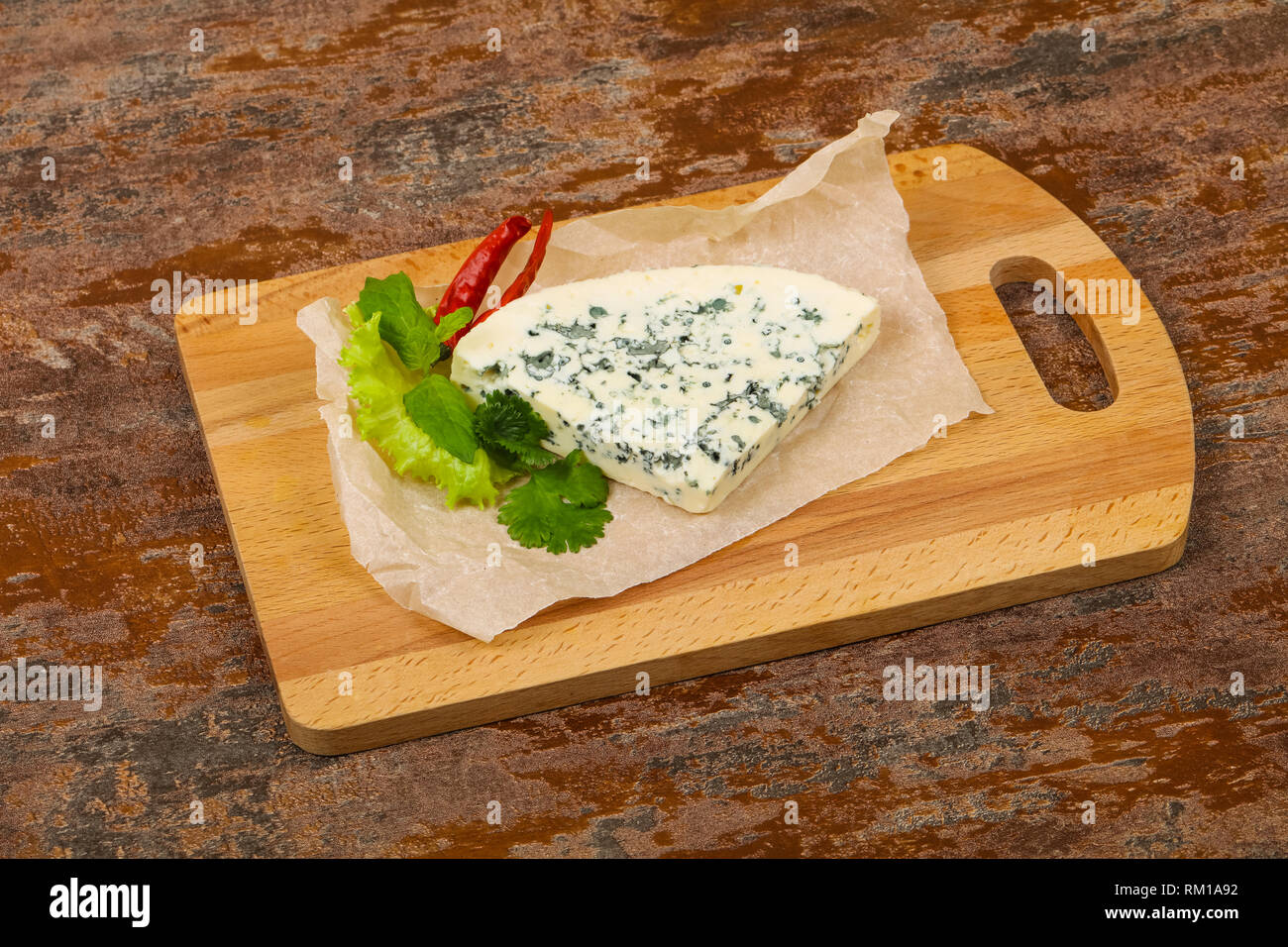 Blue cheese slice with salad leaves Stock Photo - Alamy