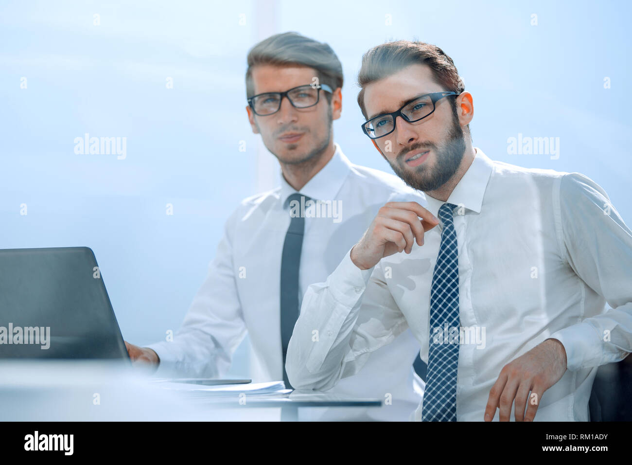 two business people sitting at the office Desk Stock Photo - Alamy