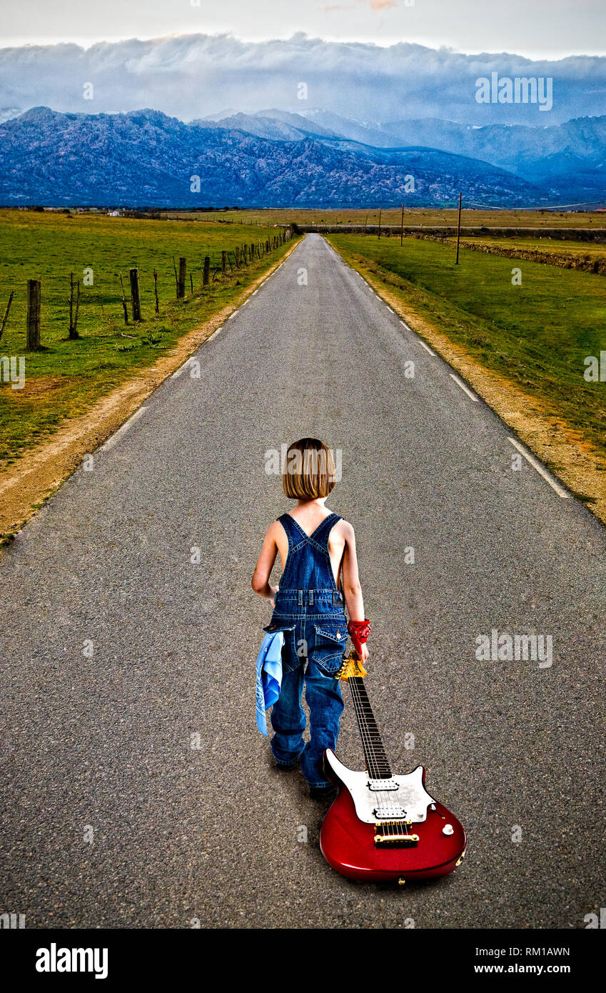 Child dragging a red guitar on the road Stock Photo - Alamy