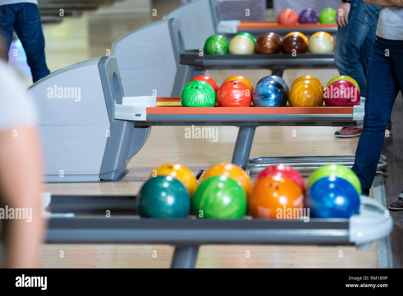 Colorful bowling balls; people playing bowling Stock Photo - Alamy