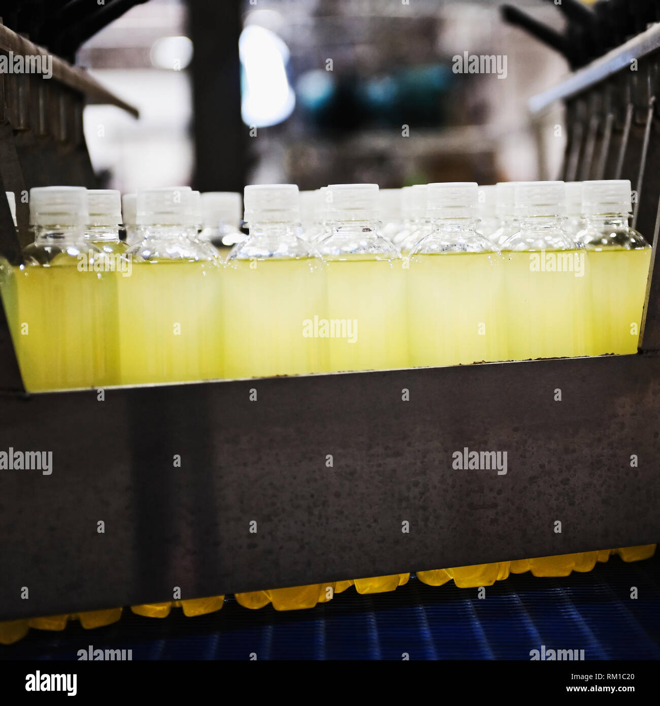 Filled bottles on conveyor hi-res stock photography and images - Alamy