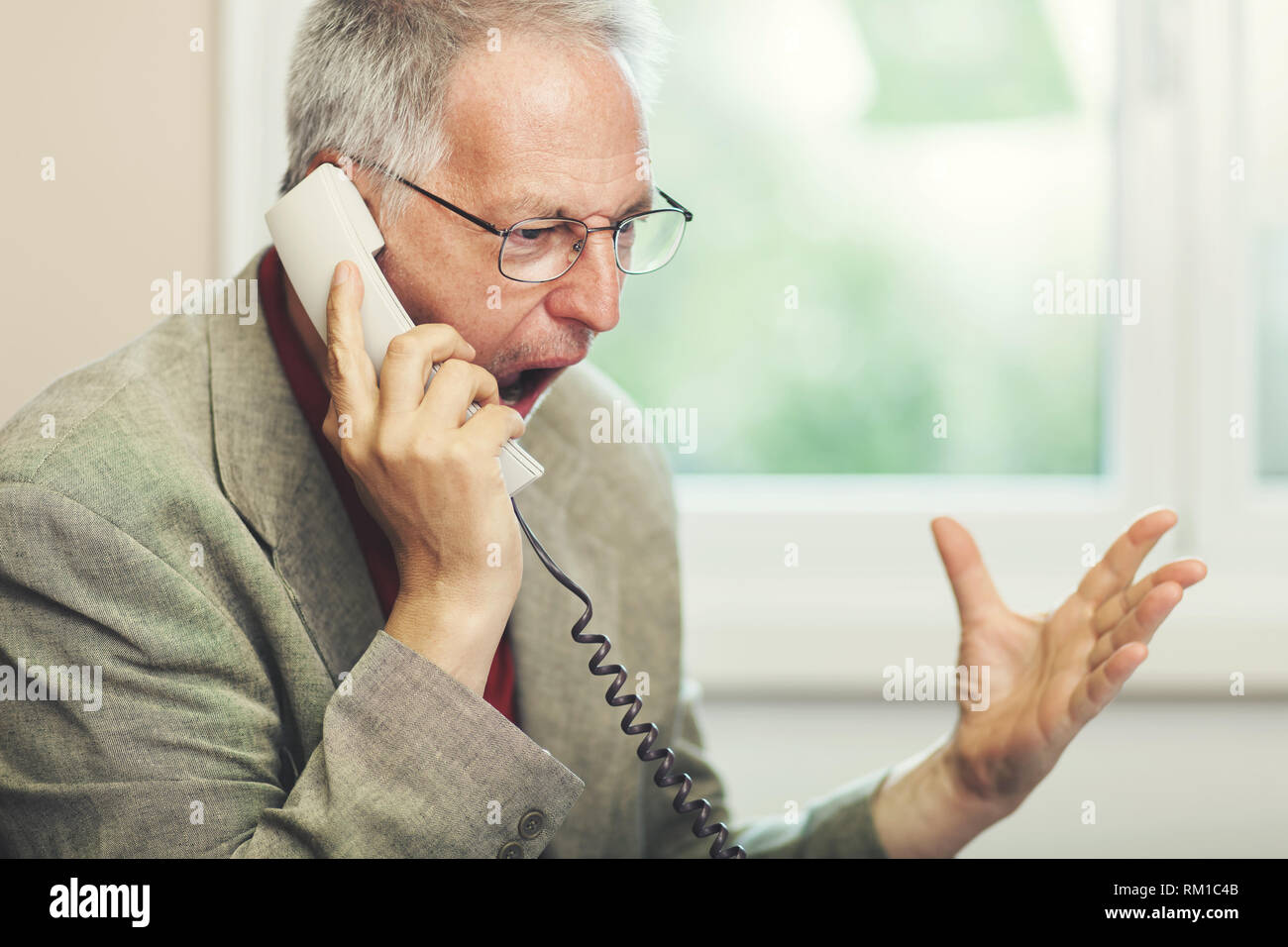 Angry businessman shouting on the phone Stock Photo - Alamy