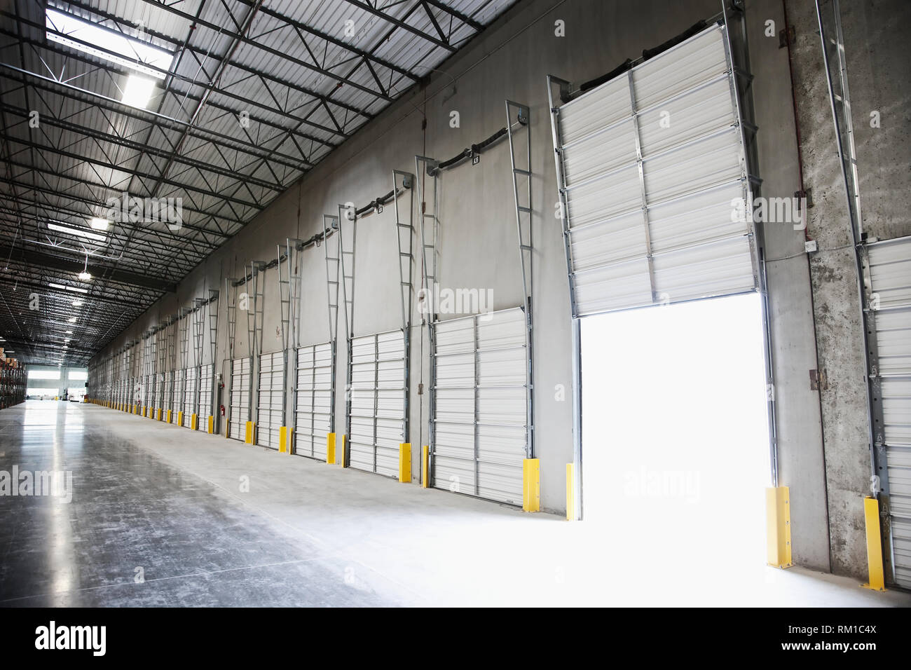 Open door at loading dock in warehouse Stock Photo - Alamy