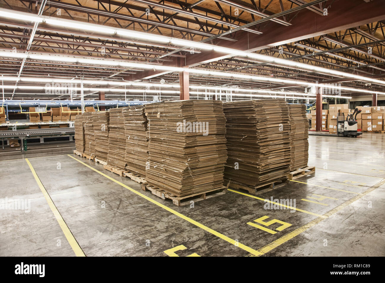 Flattened cardboard boxes in warehouse Stock Photo - Alamy
