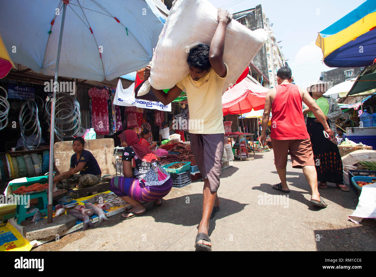 Shoulder transport of goods, market in the 26th street, city center ...