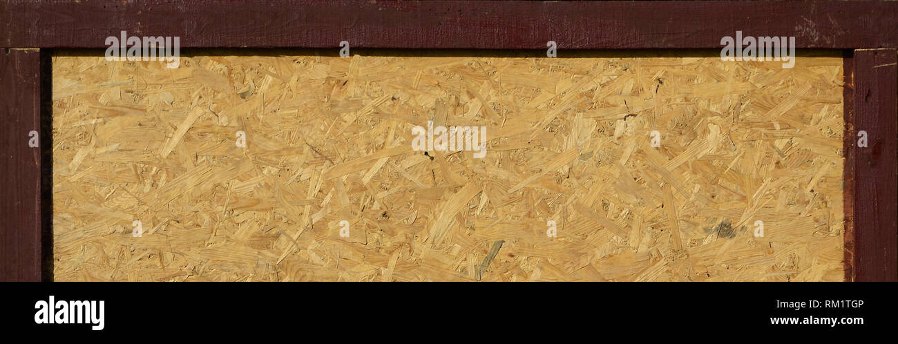 OSB boards are made of brown wood chips sanded into a wooden background ...