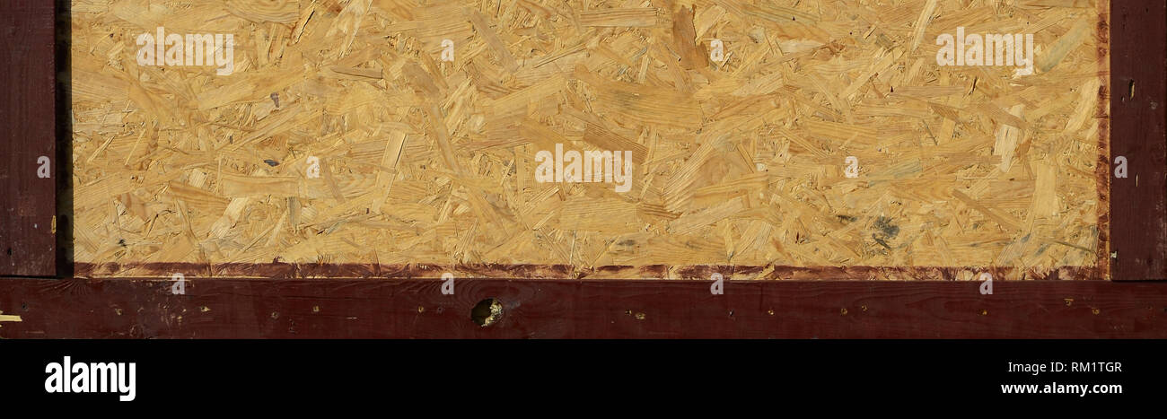 OSB boards are made of brown wood chips sanded into a wooden background ...
