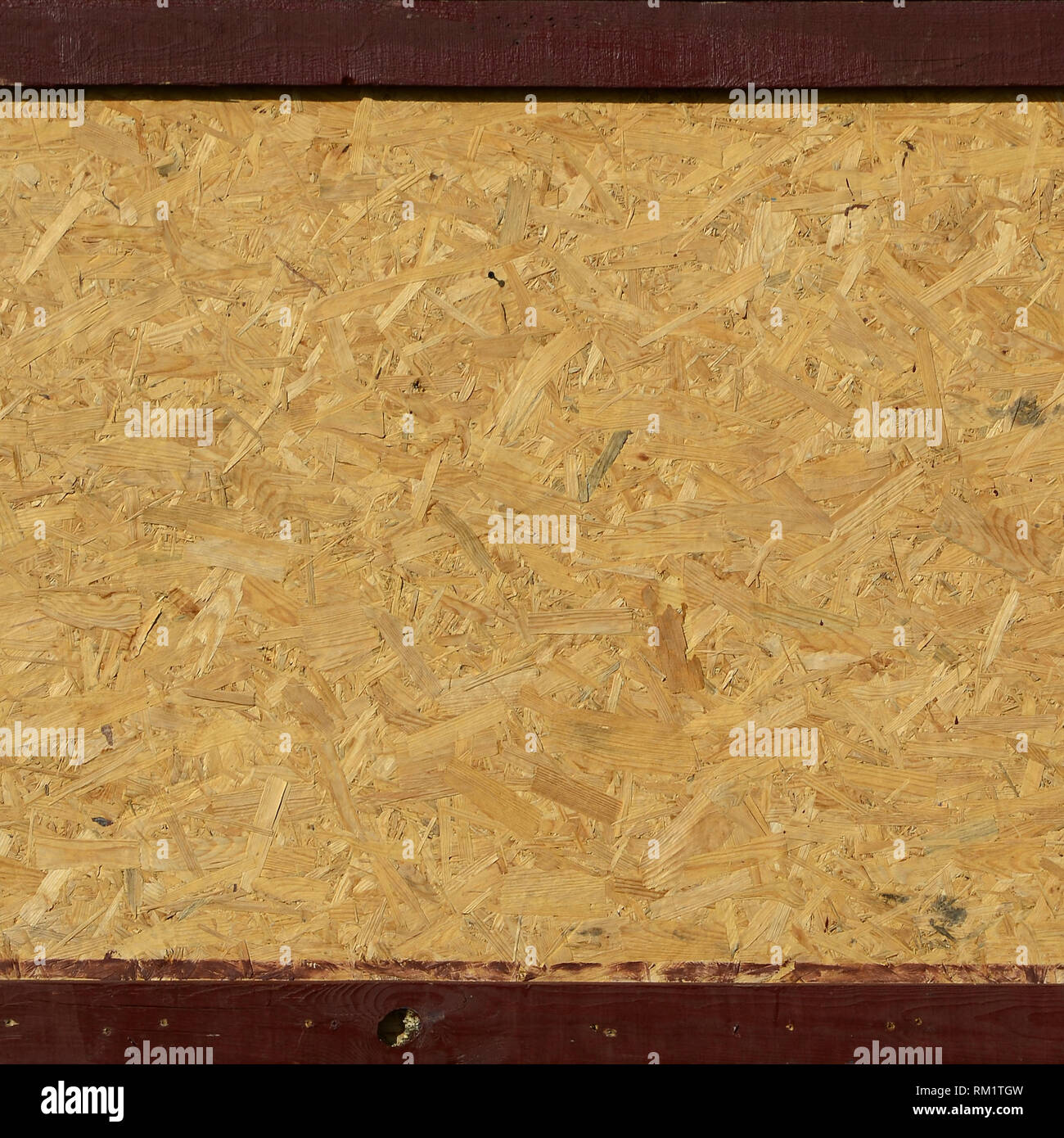 OSB boards are made of brown wood chips sanded into a wooden background ...