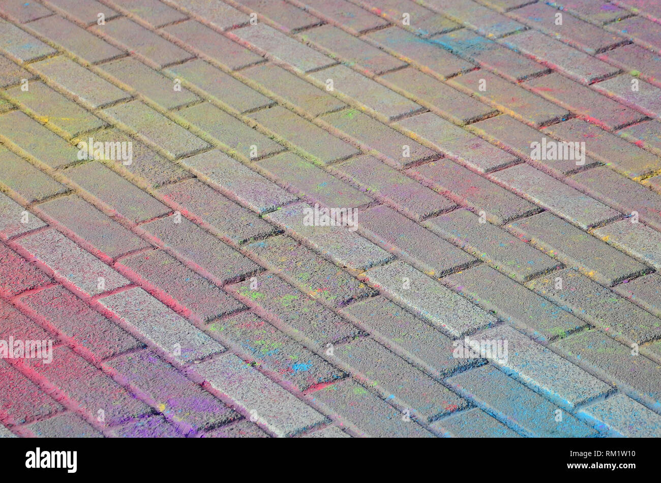 Multi colored earth, paving slabs, powder coated with dry colors at the ...
