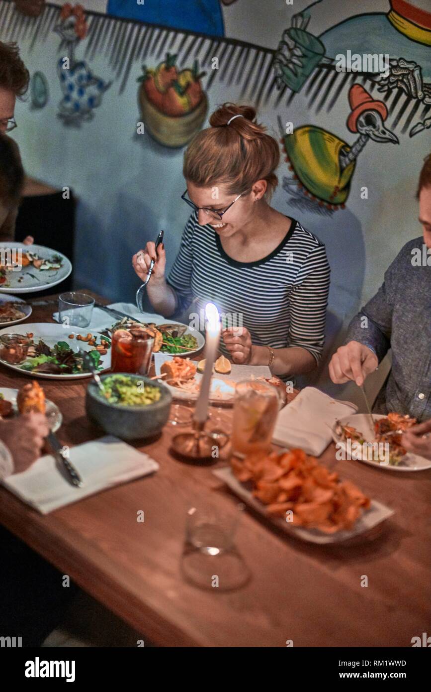 woman enjoying dinner with friends in restaurant Blitz, Museumsinsel ...