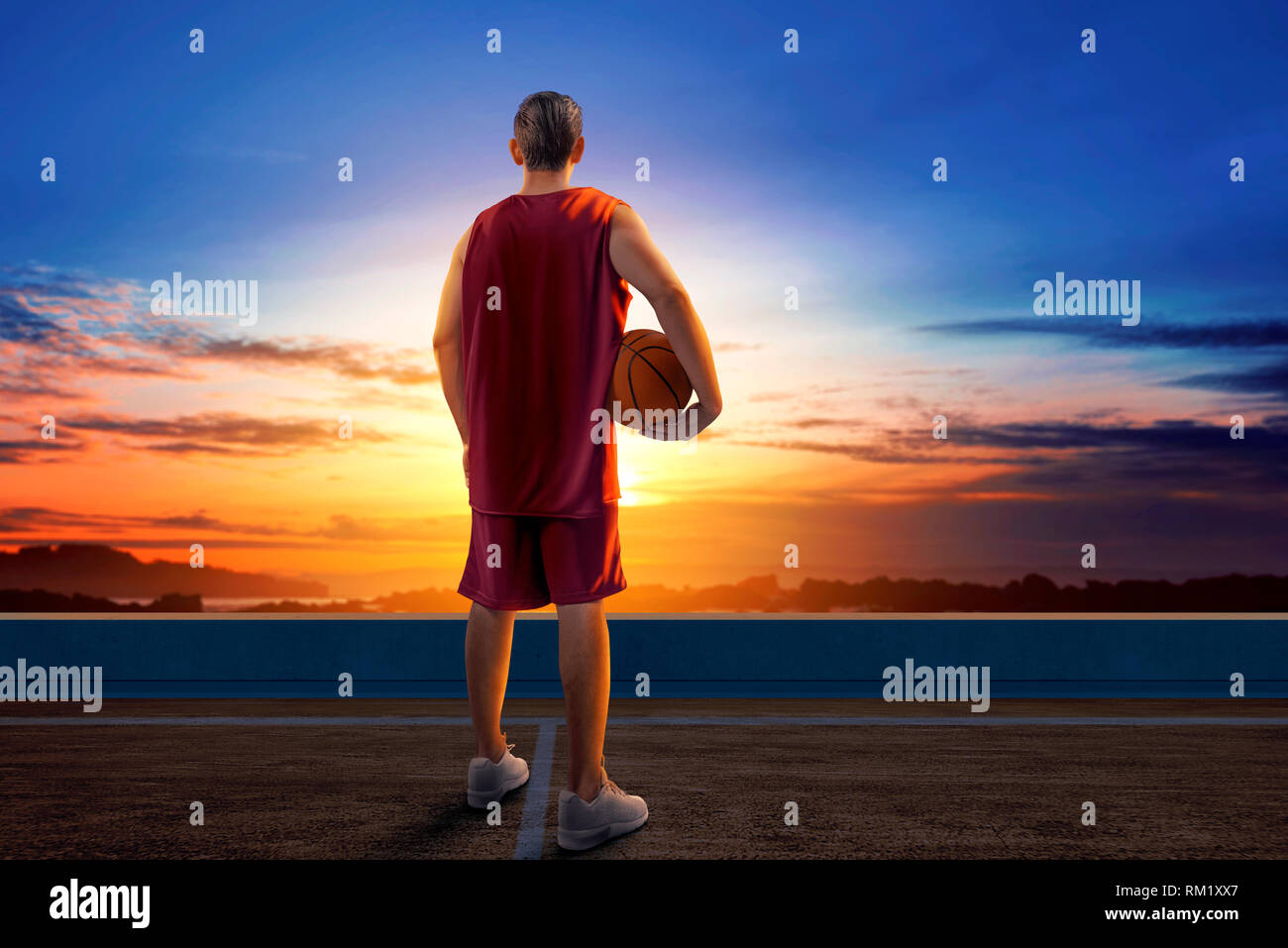Rear view of asian man basketball player holding the ball start the ...