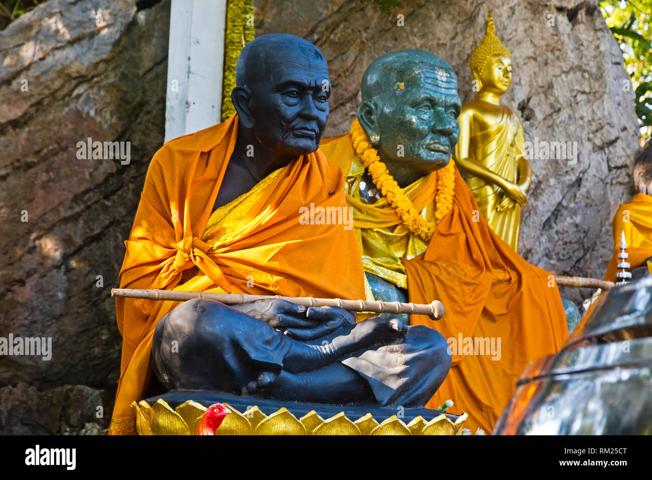 Statues of famous Buddhist monks on a small rock in the ocean of KHANOM ...