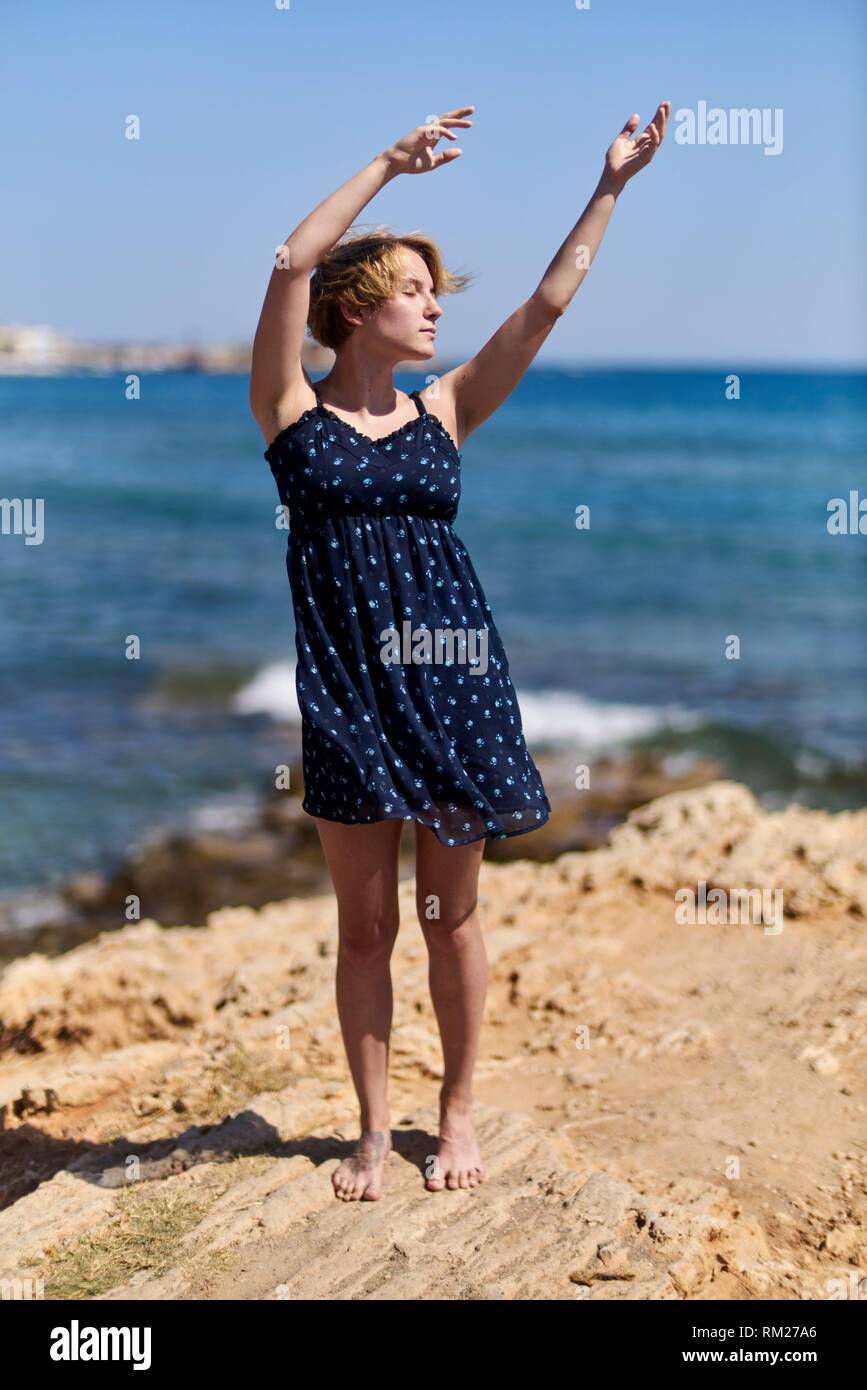 Woman Dancing At Beach Sensual Enjoying Warm Summer Breeze In Holiday Destination