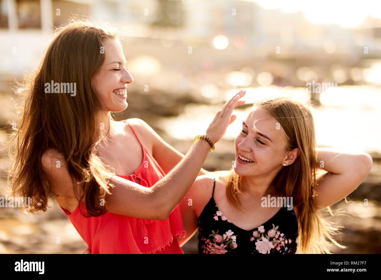 two women, friends, at beach, togetherness in holiday destination ...