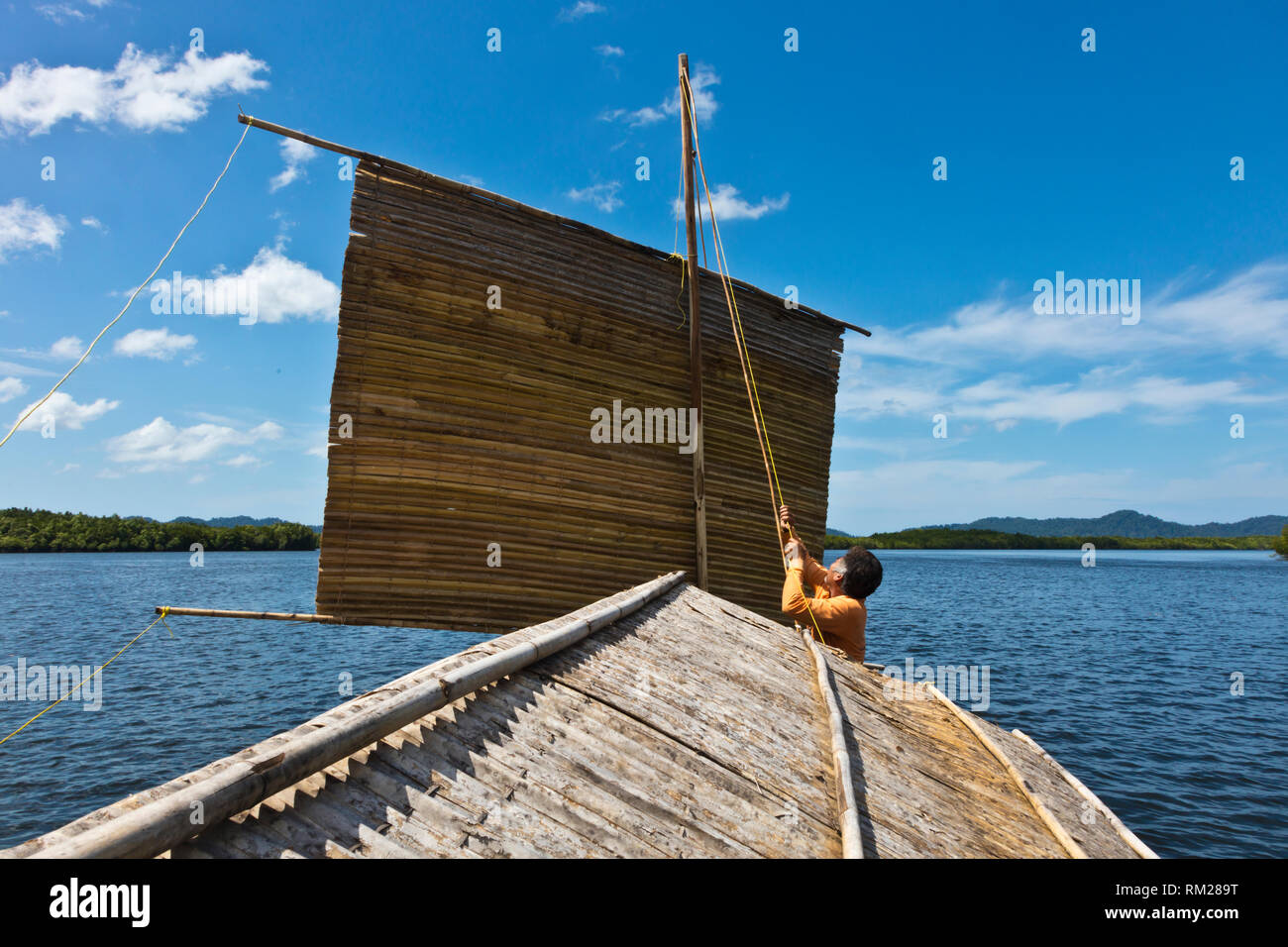 A MOKEN MAN sails his traditional boat to KHO RA ISLAND in the Andaman ...