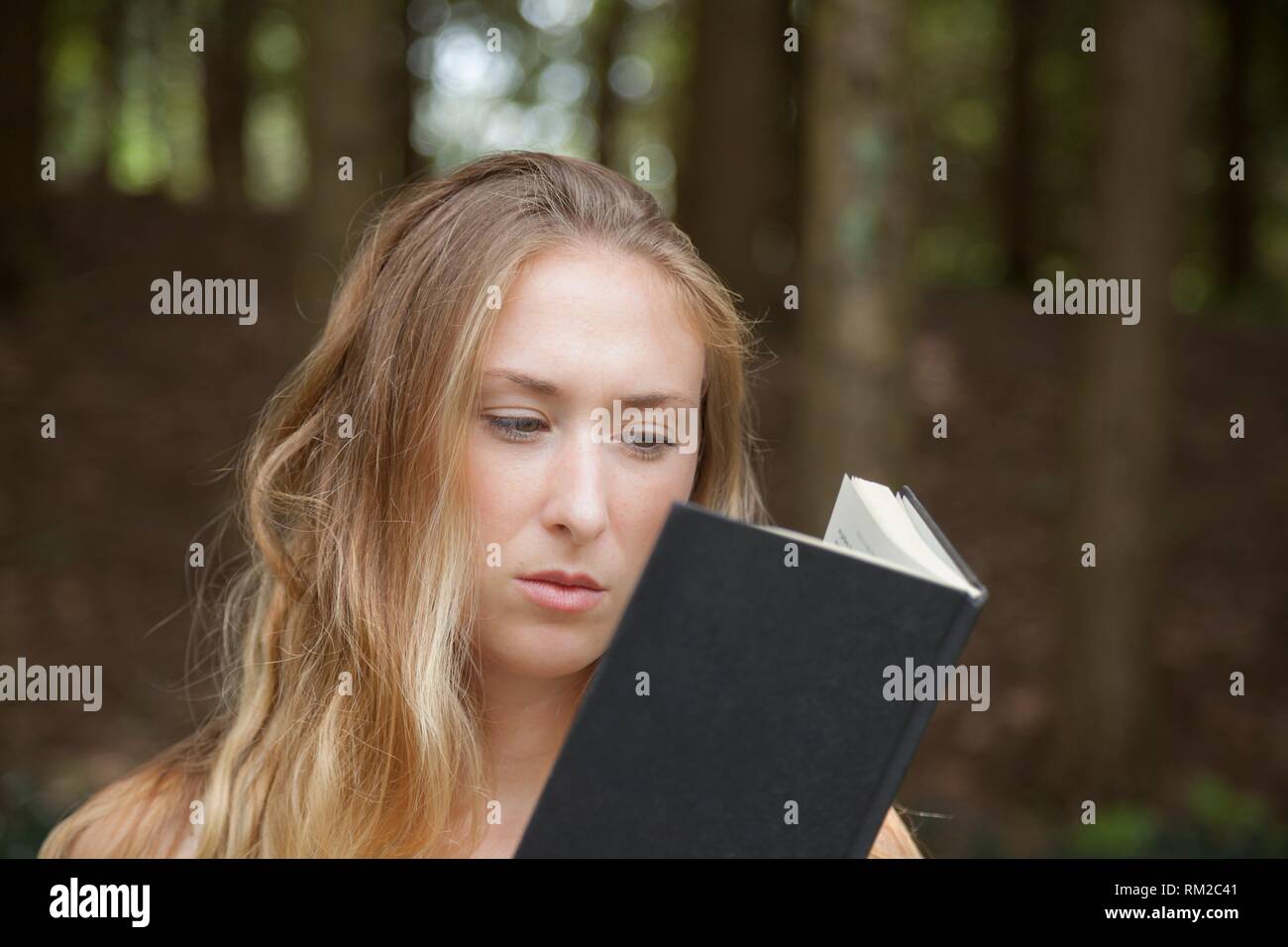 Woman reading book forest in hi-res stock photography and images - Alamy