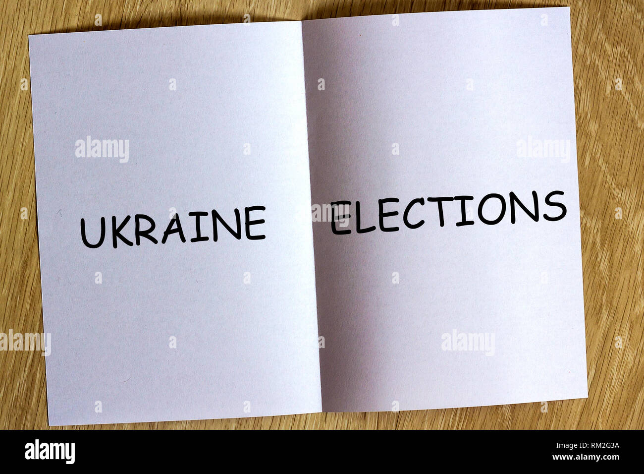 White sheen of paper on wooden background with text "Ukraine elections ...