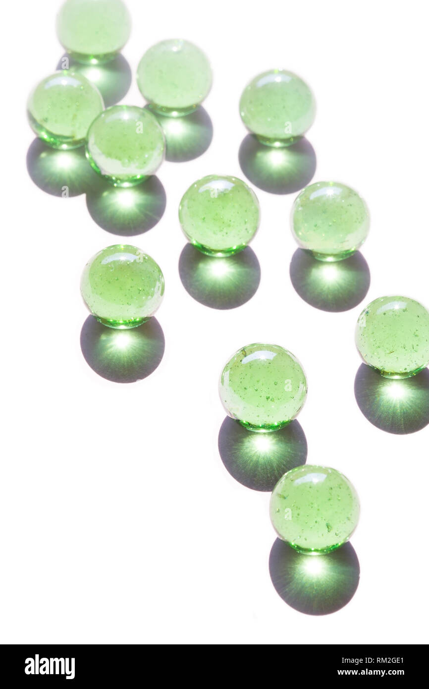 Green glass marbles with shadows Stock Photo - Alamy