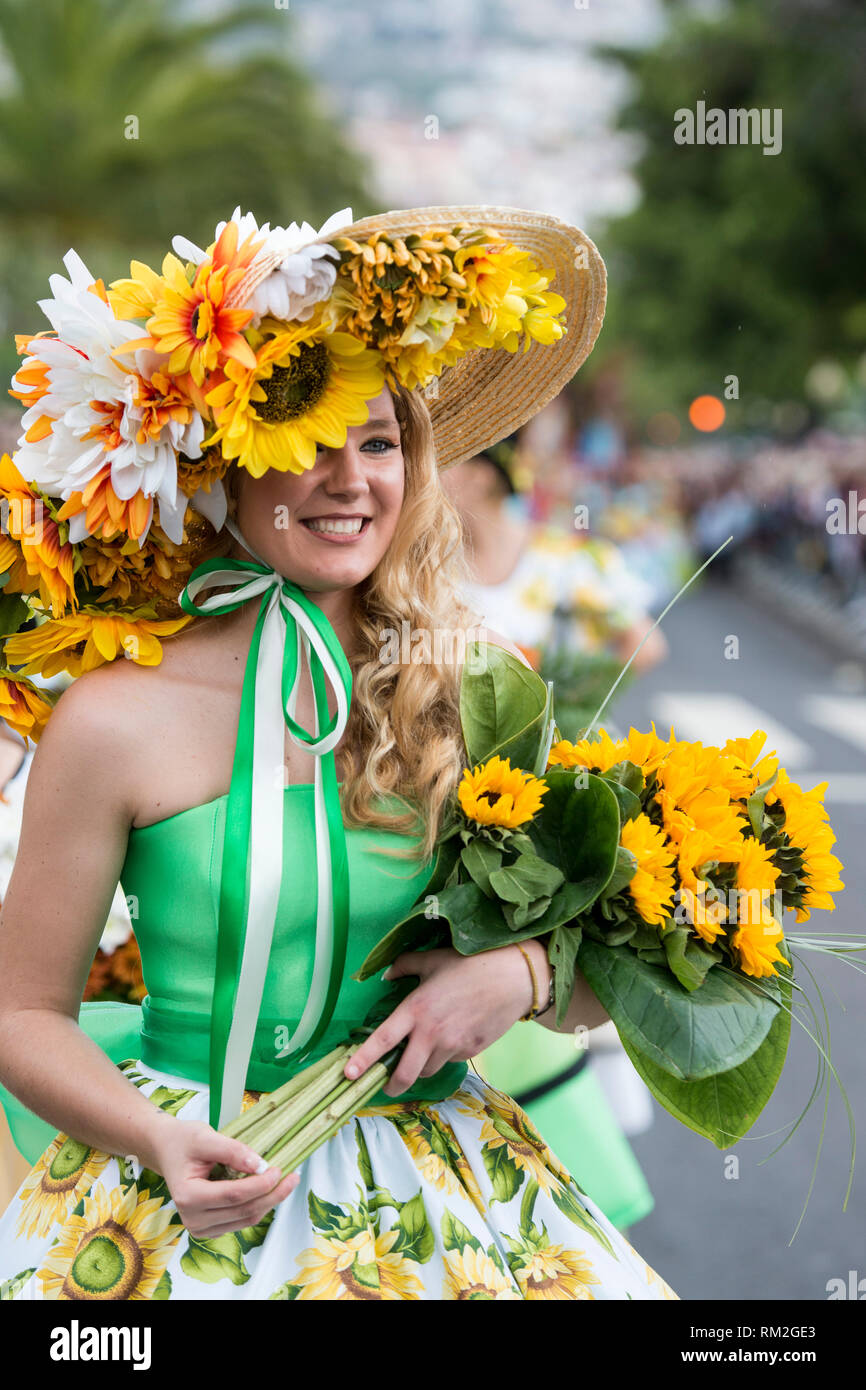 women dressed in colorful clothes at the Festa da Flor or Spring Flower ...