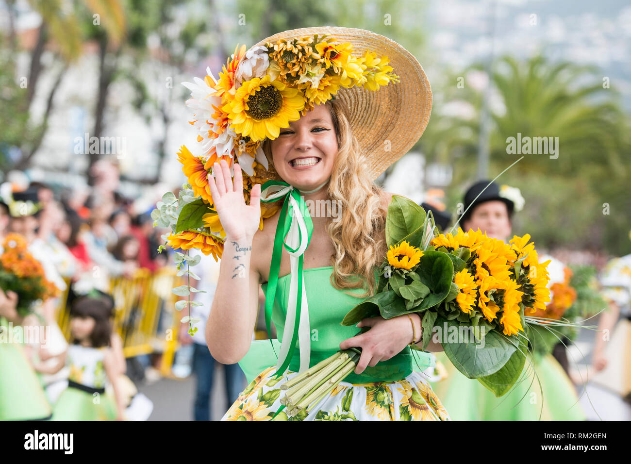 women dressed in colorful clothes at the Festa da Flor or Spring Flower ...