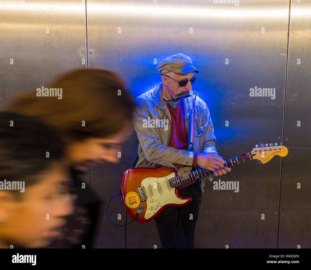 Male busker fort william underpass entertains as strangers pass by ...